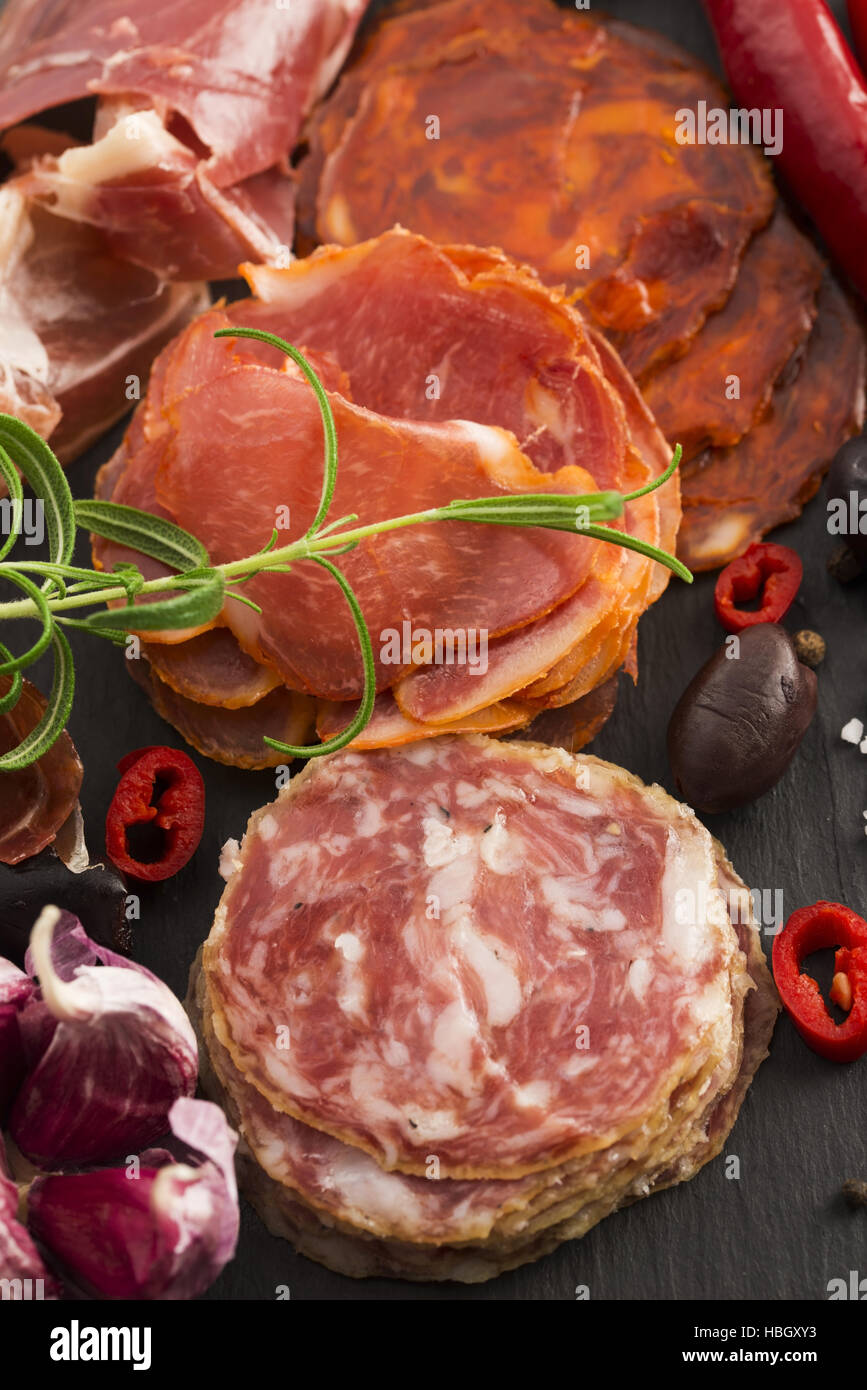 a pile of different spanish embutido, jamon, chorizo and lomo embuchado ...