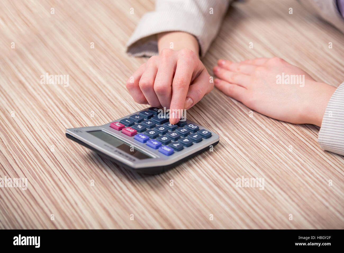 Hands working on the calculator Stock Photo - Alamy