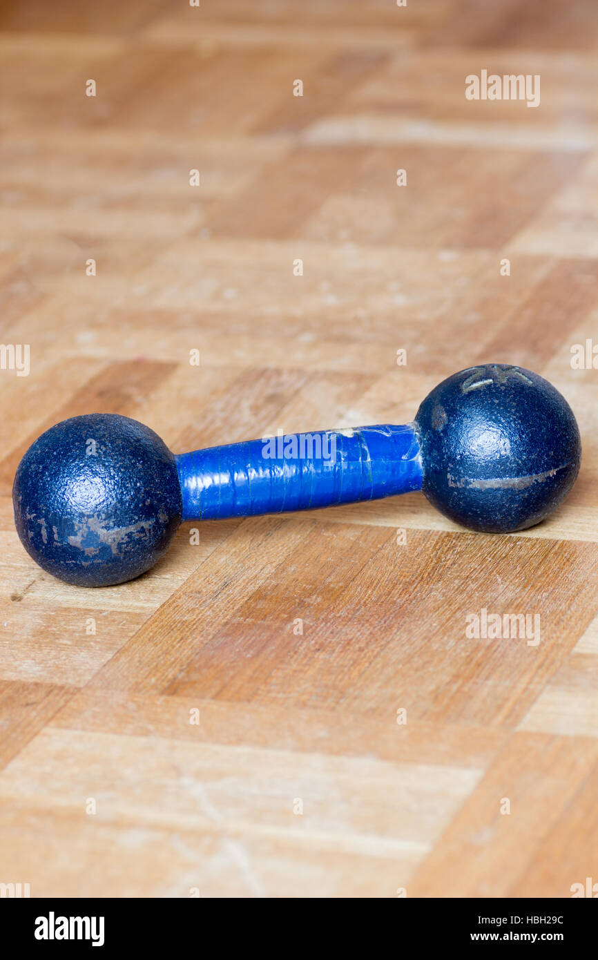 metal small light dumbbell on the wooden floor Stock Photo - Alamy