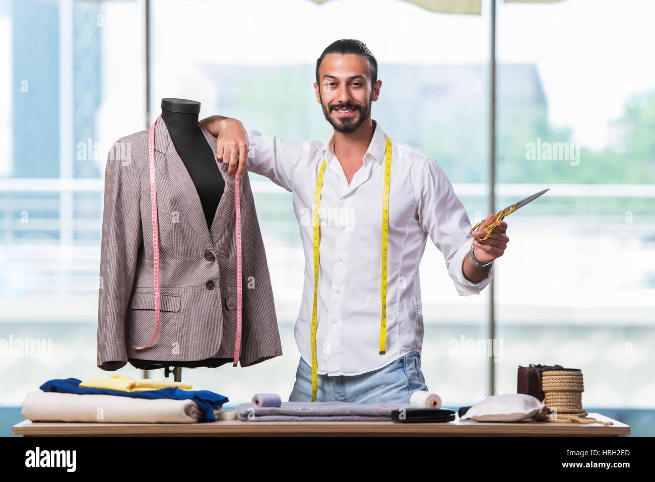 Young tailor working on new clothing design Stock Photo - Alamy