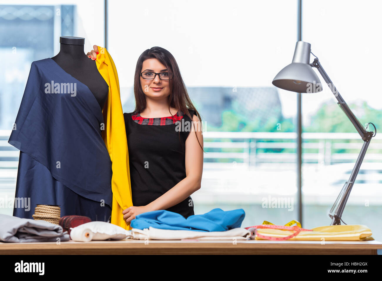 Woman tailor working on new clothing Stock Photo - Alamy