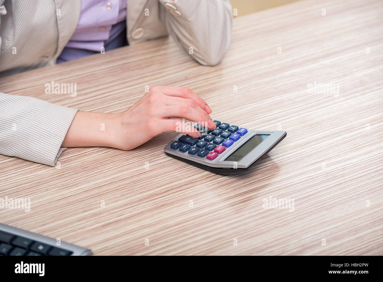 Hands working on the calculator Stock Photo - Alamy