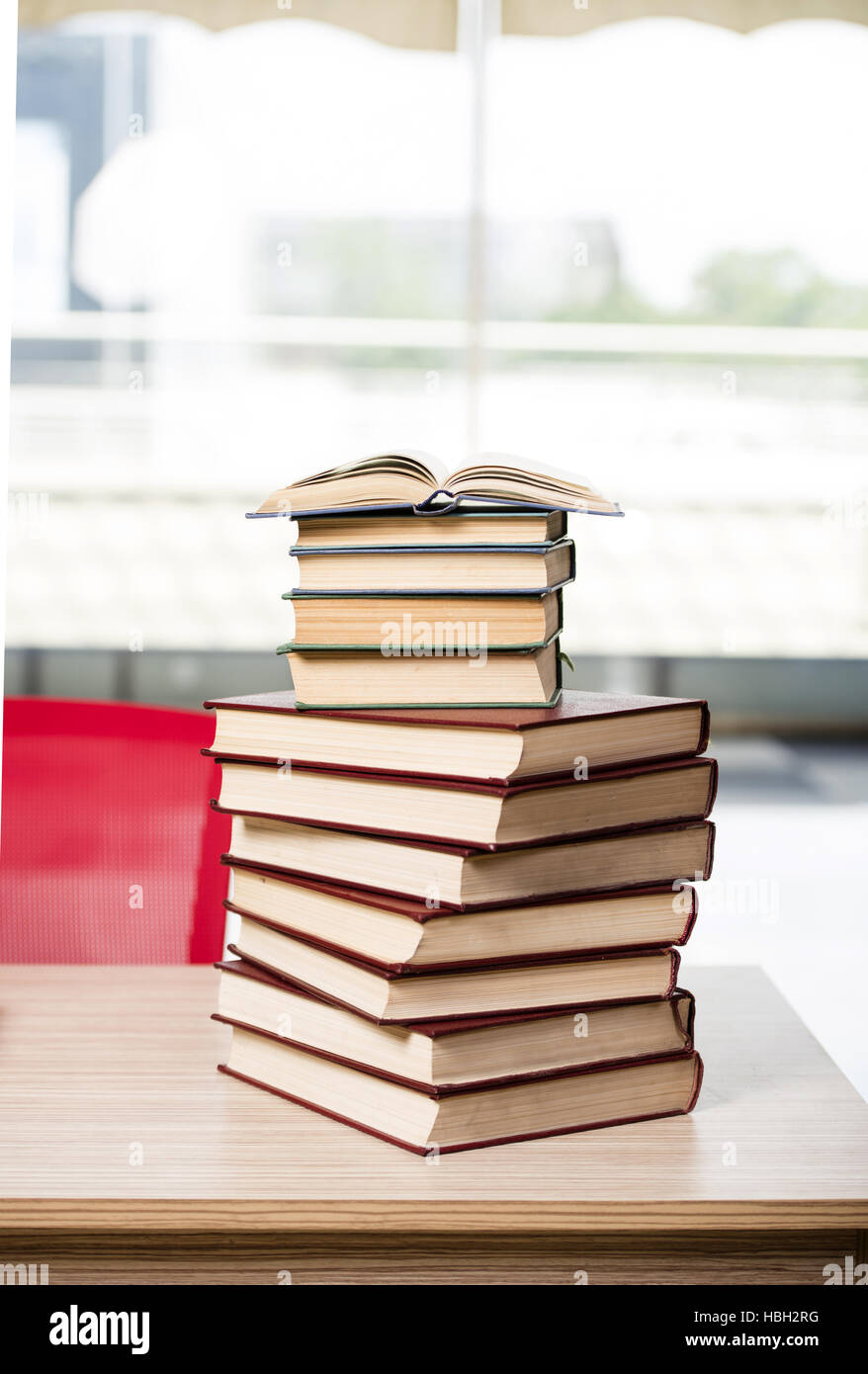 Stack of books arranged the office desk Stock Photo - Alamy