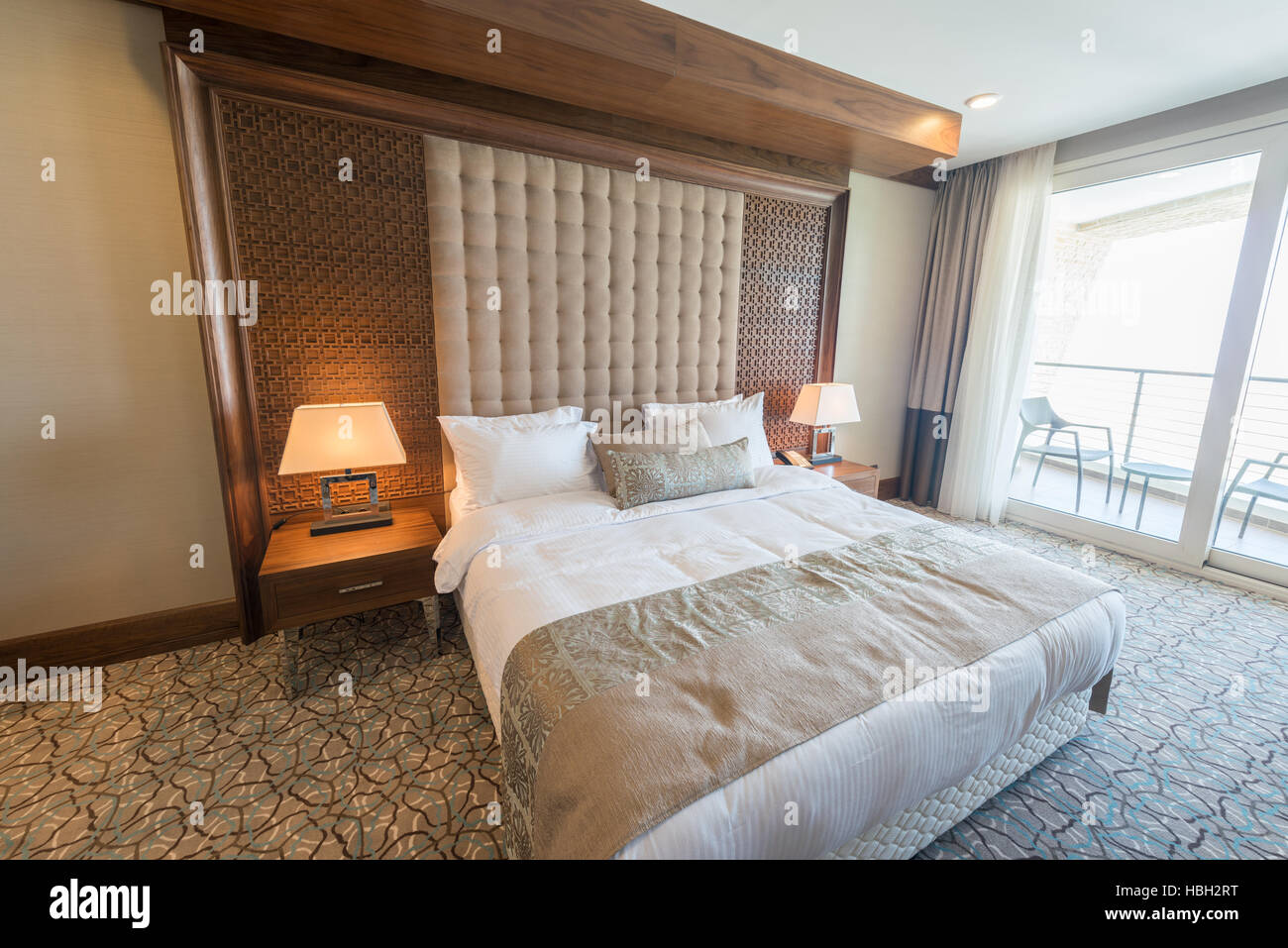 Modern hotel room with big bed Stock Photo - Alamy