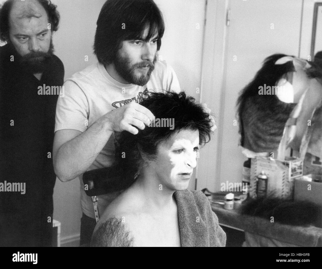 AN AMERICAN WEREWOLF IN LONDON, Rick Baker, center, applies makeup to ...