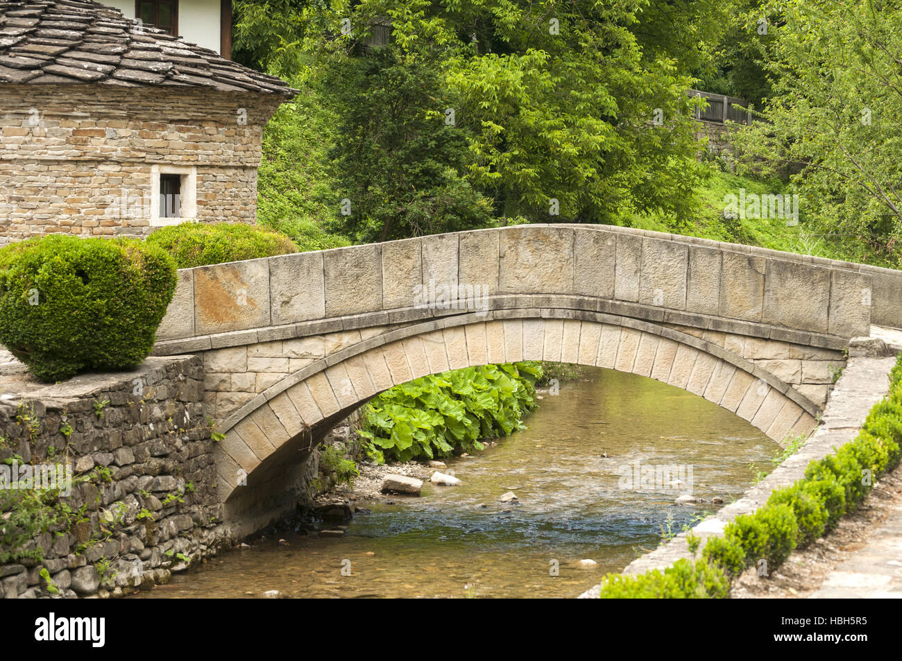 Stone countryhouse and stone bridge Stock Photo - Alamy