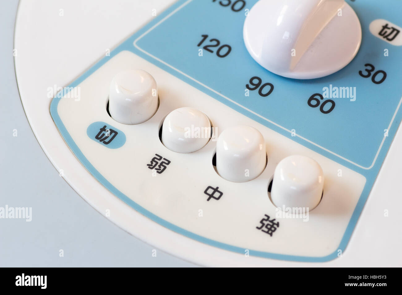 Power switching device on a white and blue Japanese electric fan Stock ...