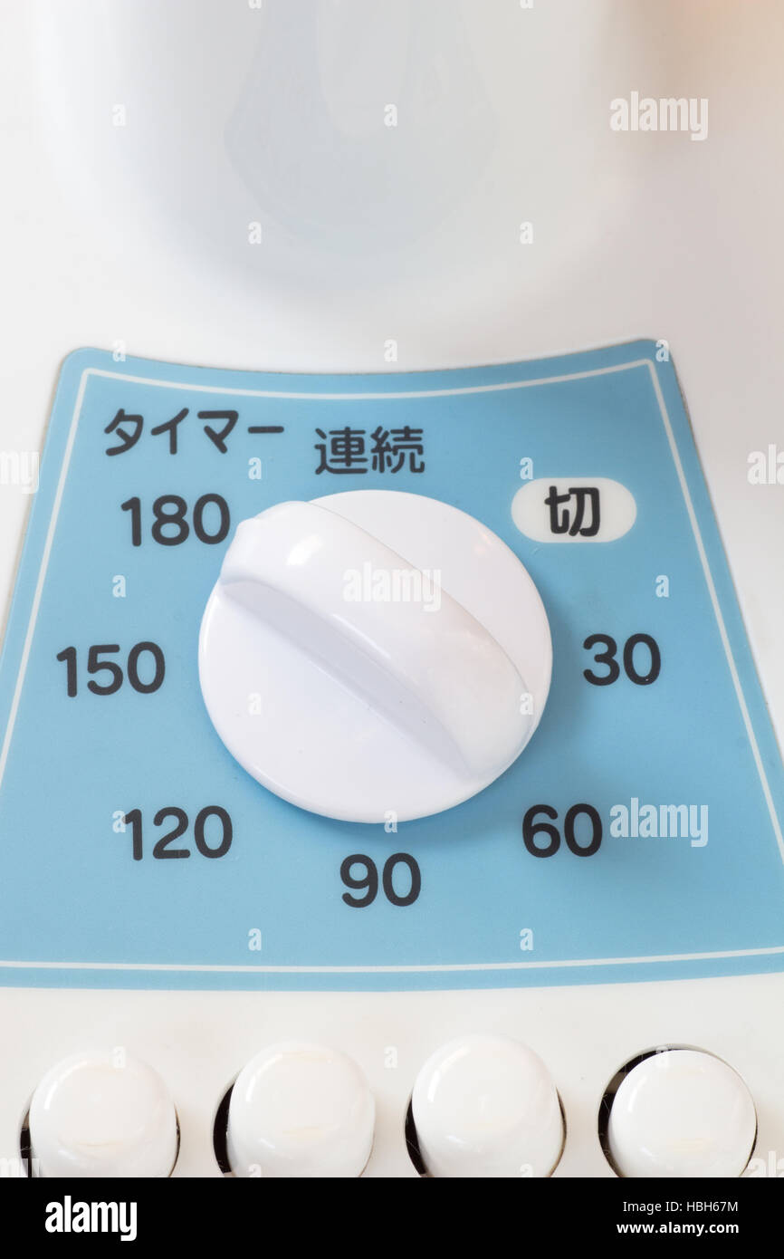 Analog timer device of a bule and white Japanese electric fan Stock ...