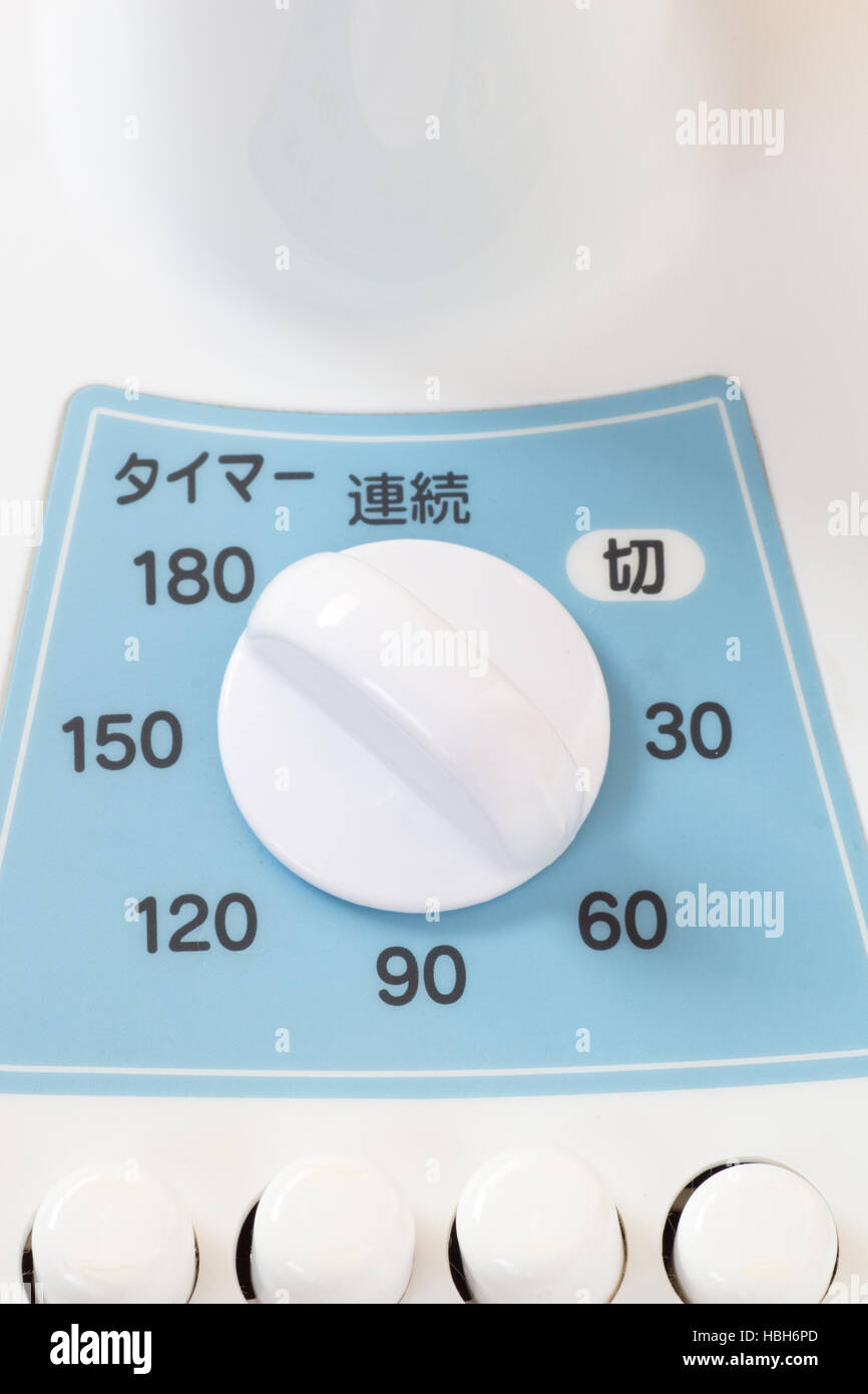Analog timer device of a bule and white Japanese electric fan Stock ...