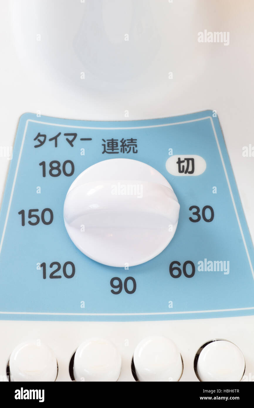 Analog timer device of a bule and white Japanese electric fan Stock ...