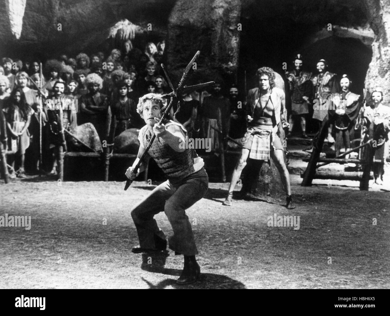 AT THE EARTH'S CORE, Doug McClure, Cy Grant (back), 1976 Stock Photo ...