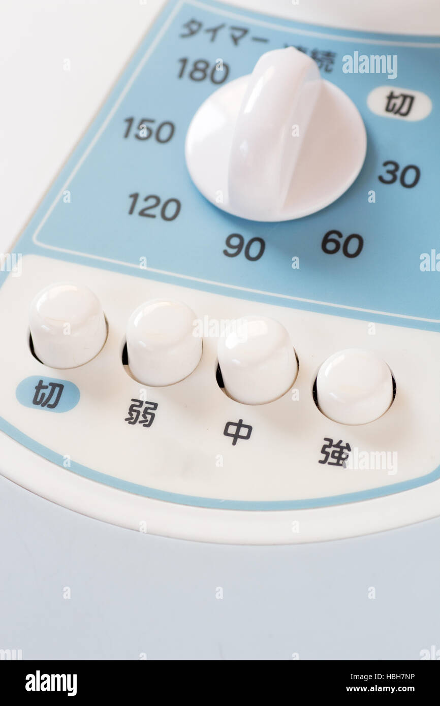 Power switching device on a white and blue Japanese electric fan Stock ...