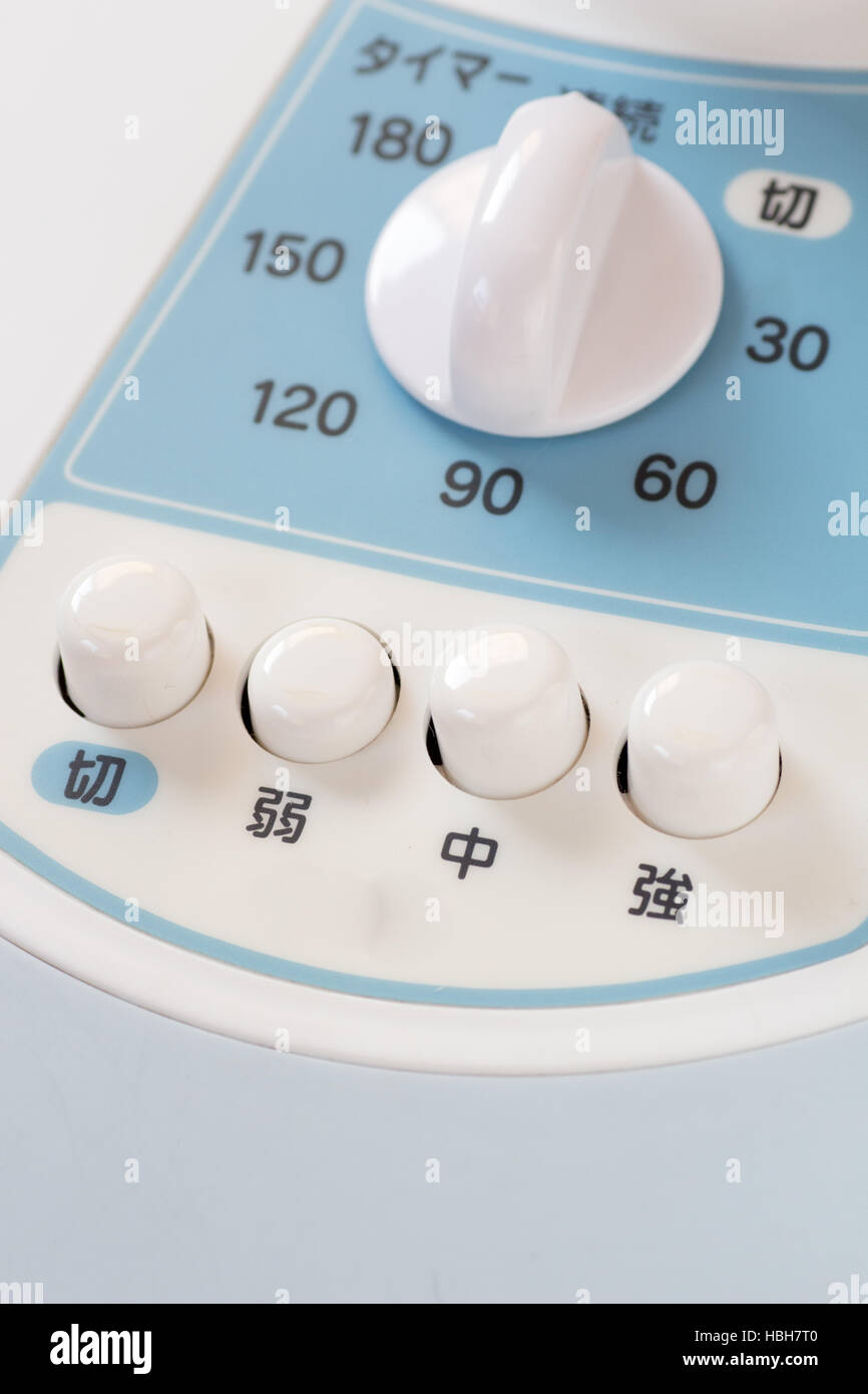 Power switching device on a white and blue Japanese electric fan Stock ...