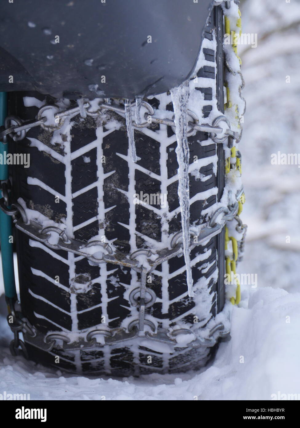 Close-up of car tyre fasten with chain Stock Photo - Alamy