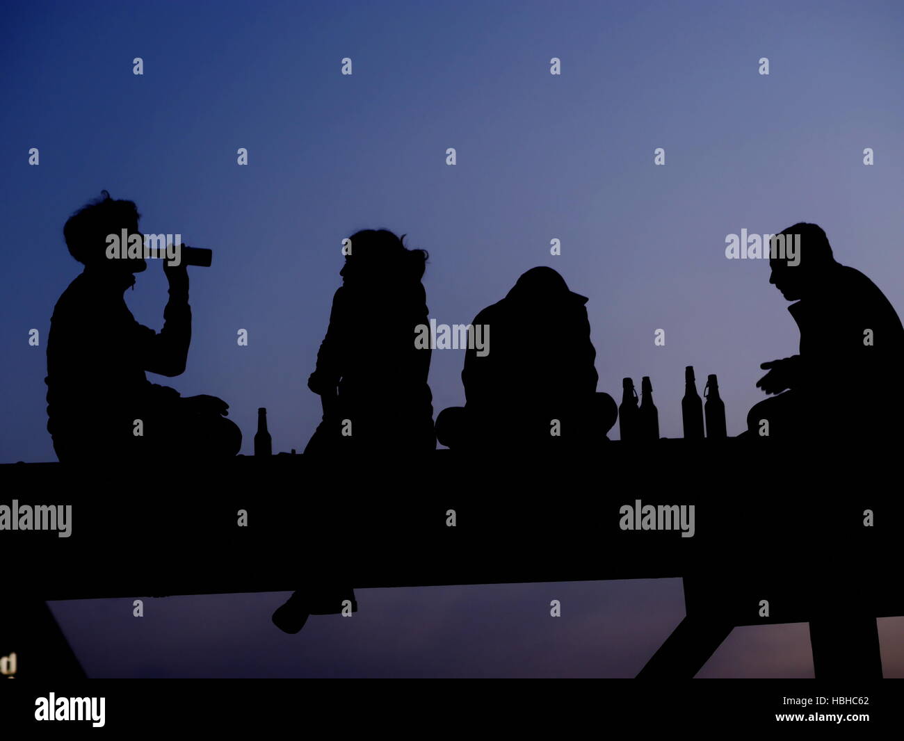 Silhouette of four friend Stock Photo - Alamy