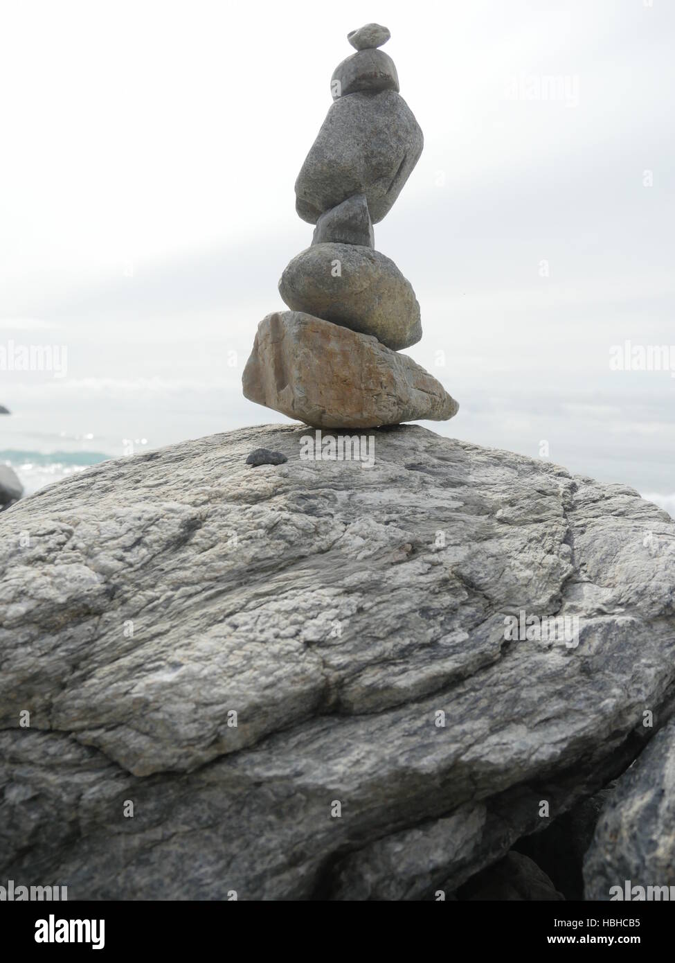 Stack of rocks balancing on sky background Stock Photo - Alamy