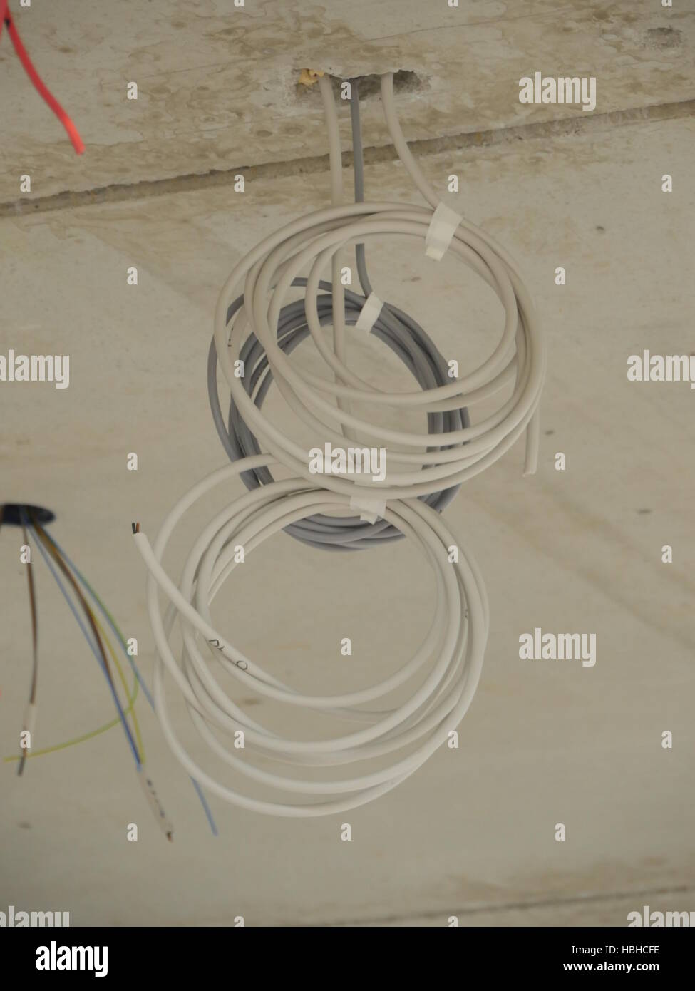 Two rolled wires sticking out of ceiling Stock Photo - Alamy