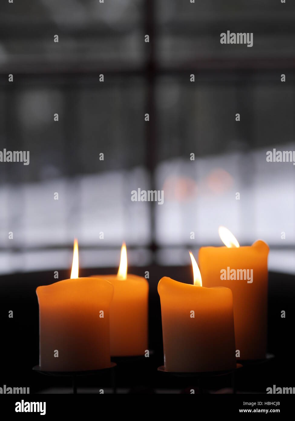 Four candles burning Stock Photo - Alamy
