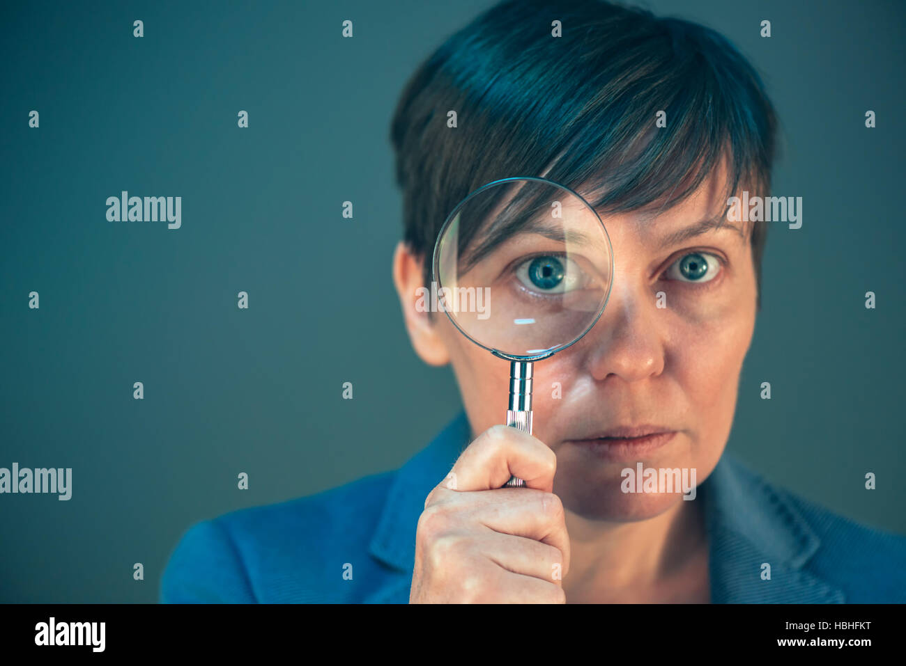Beautiful businesswoman looking through magnifying glass - search ...