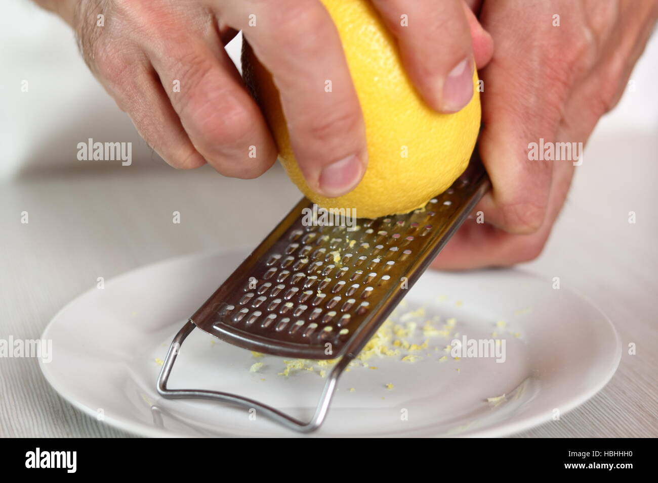 Chef grating lemon rind. Making Chicken and Egg Galette Series Stock ...