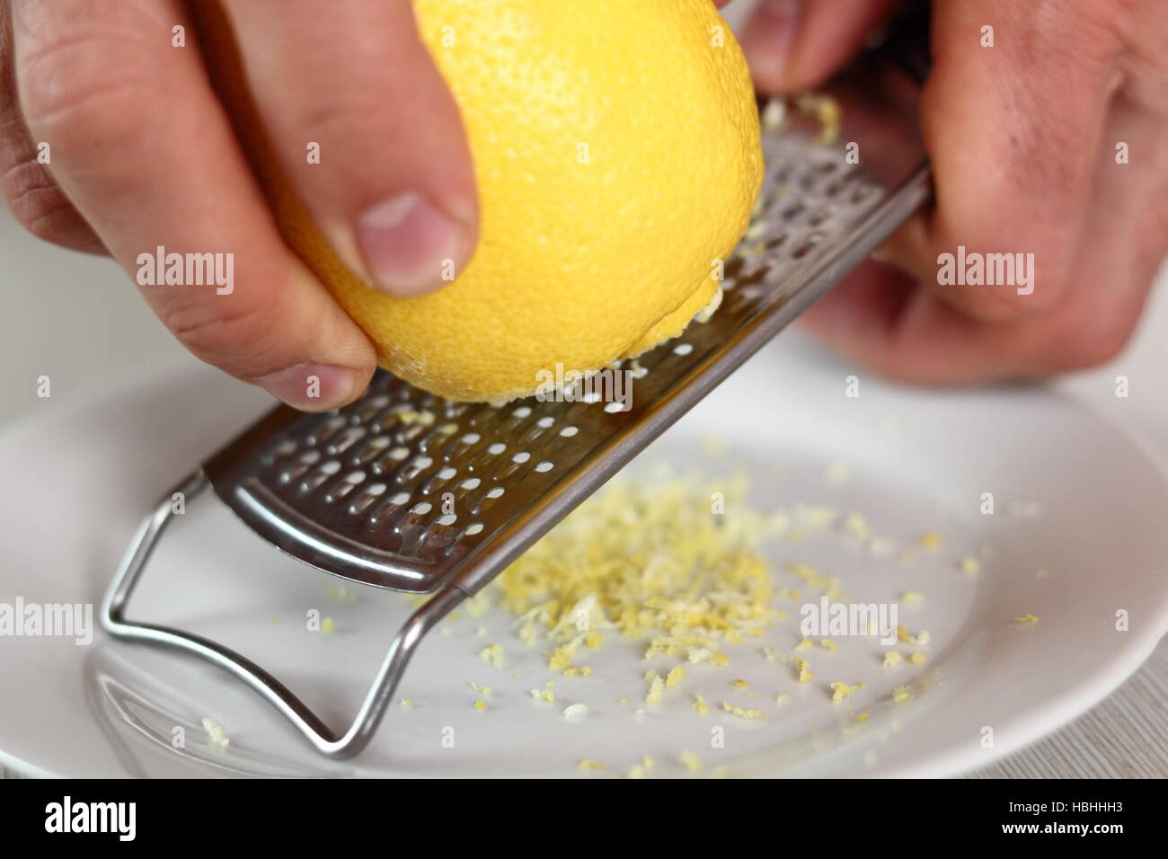 Chef grating lemon rind. Making Chicken and Egg Galette Series Stock ...