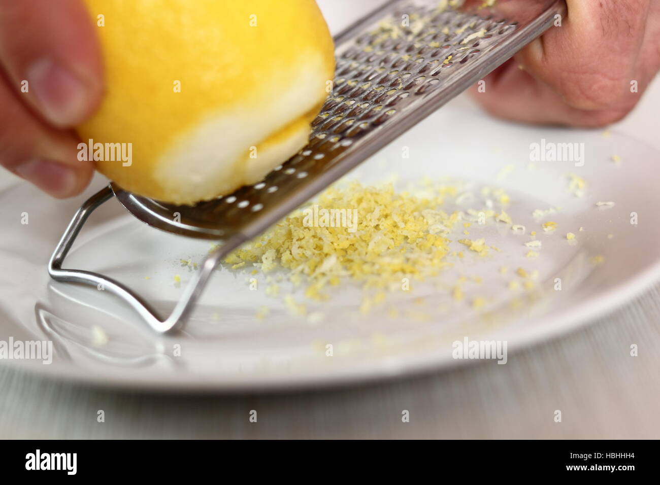 Chef grating lemon rind. Making Chicken and Egg Galette Series Stock ...