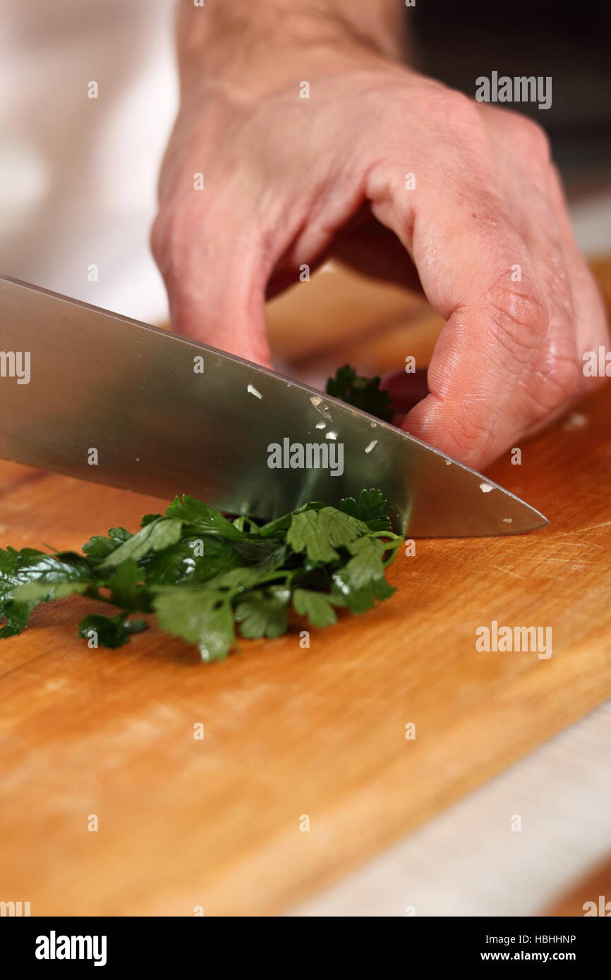 Chef slicing parsley. Making Chicken and Egg Galette Series Stock Photo ...