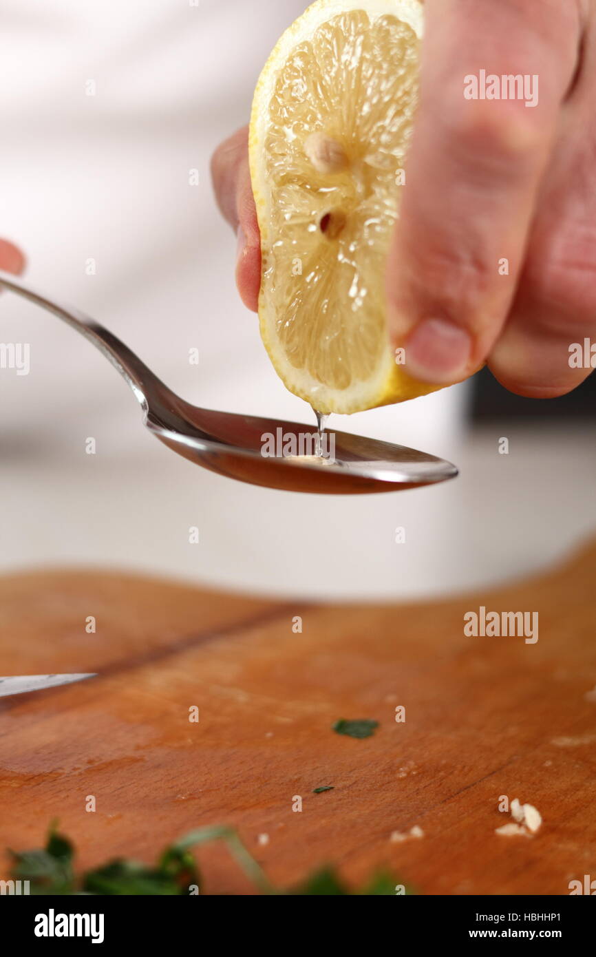 Chef squeezing lemon juice into spoon. Making Chicken and Egg Galette ...