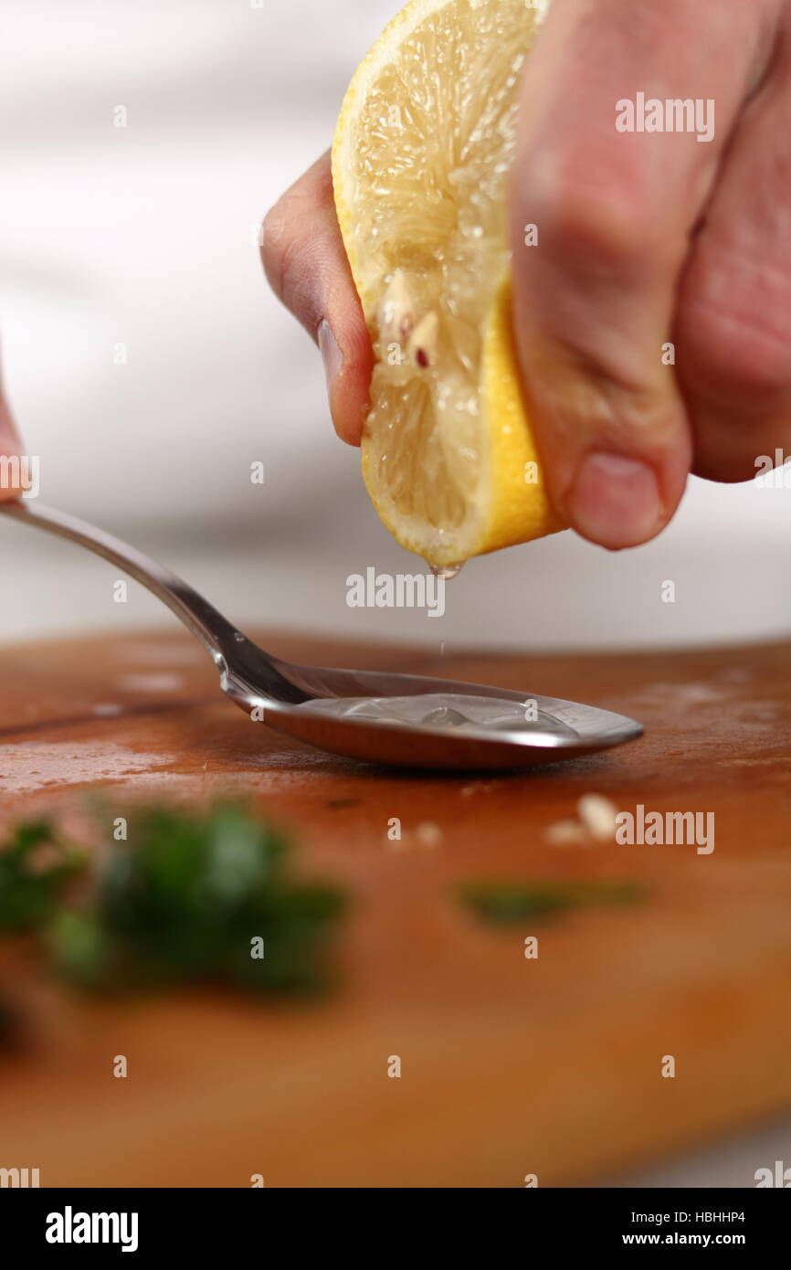 Chef squeezing lemon juice into spoon. Making Chicken and Egg Galette ...