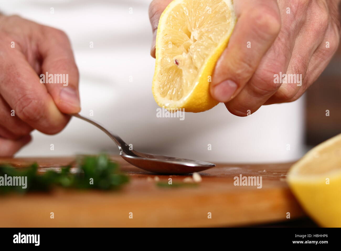 Chef squeezing lemon juice into spoon. Making Chicken and Egg Galette ...