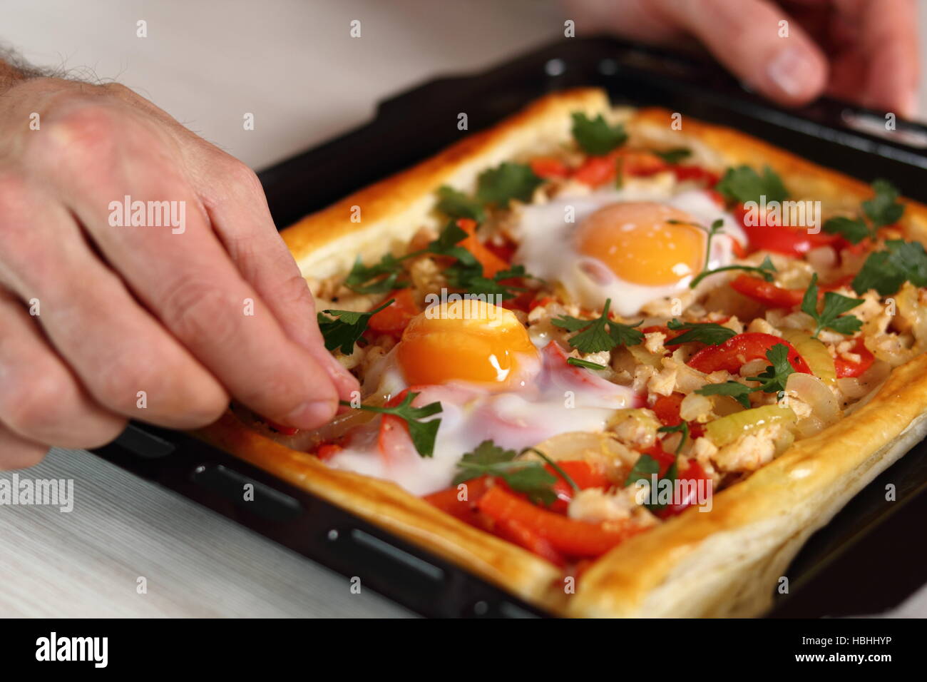 Chef garnishing pie with chopped parsley. Making Chicken and Egg ...