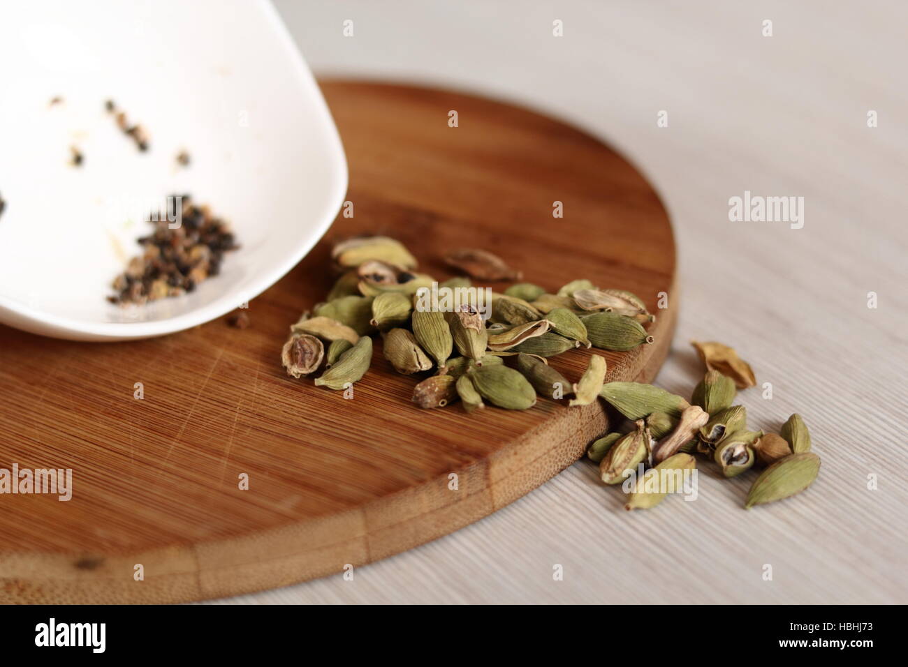 Cardamom pods and seeds on wooden board. Making Pear Tarte Tatin with ...
