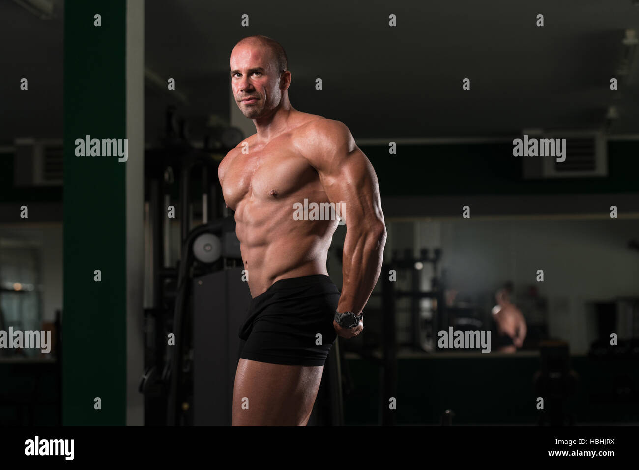 Bald muscular man flexing muscles hi-res stock photography and images ...