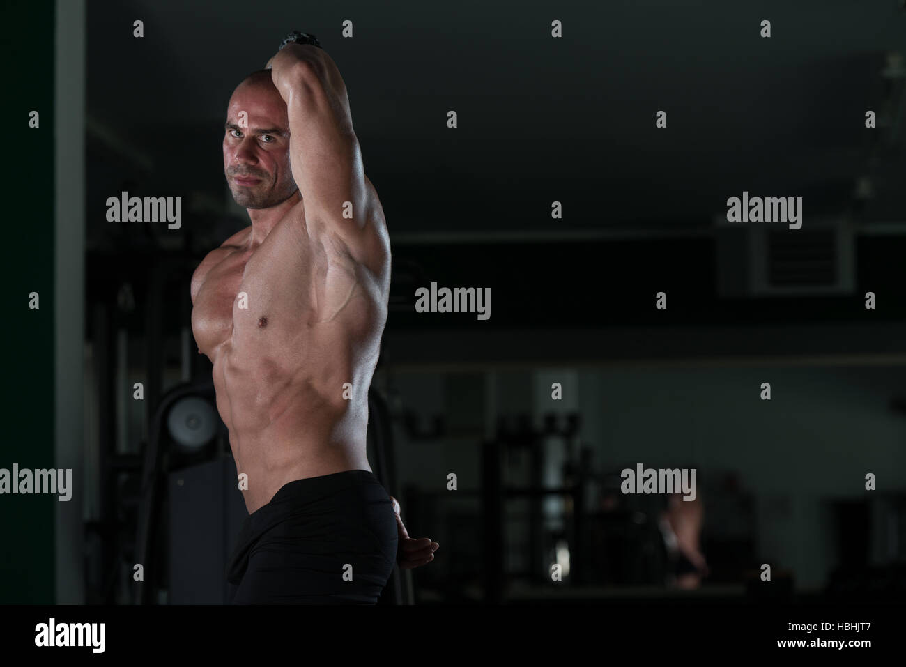 Bodybuilder Posing In Different Poses Demonstrating Their Muscles ...