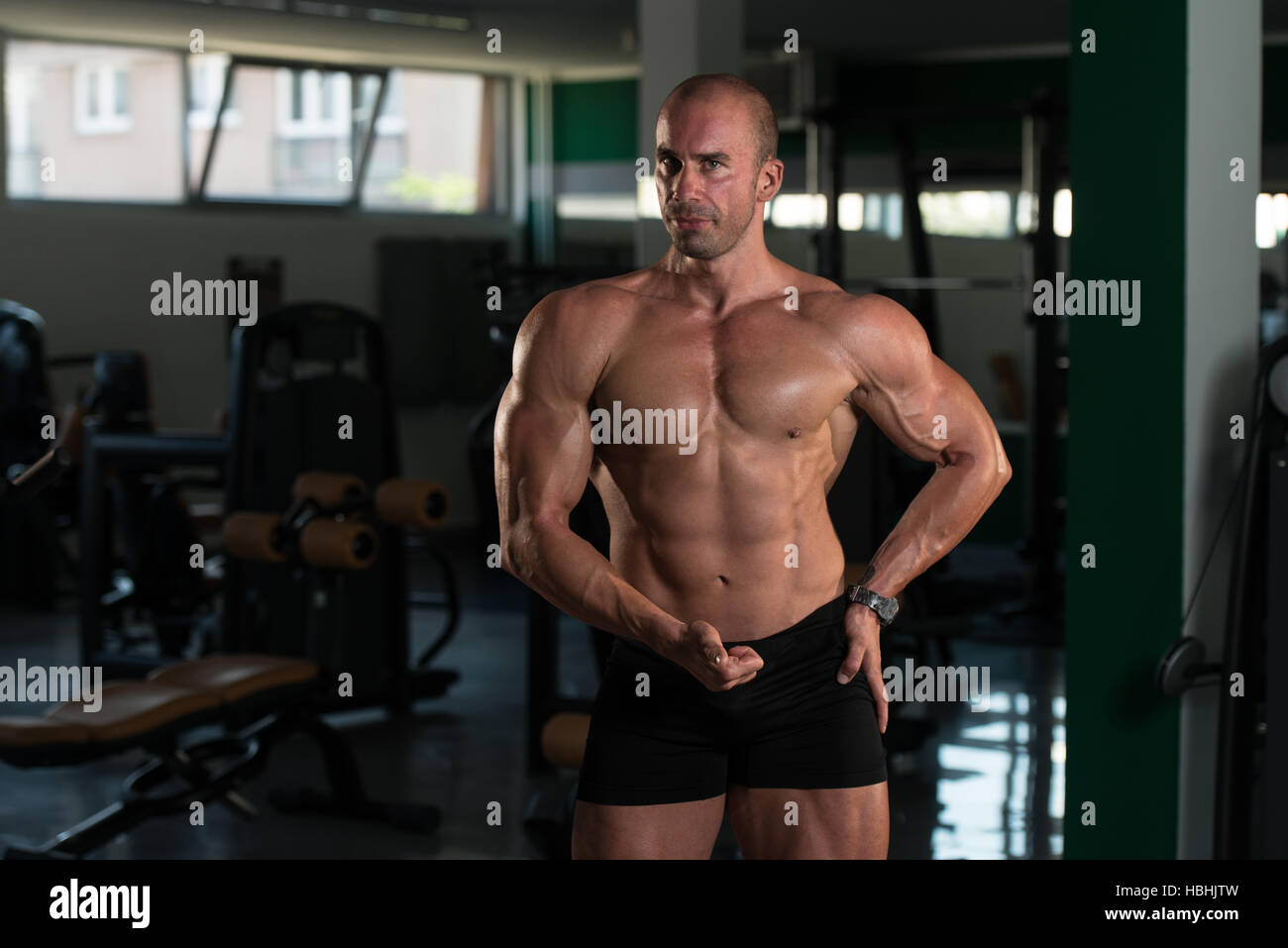 Bodybuilder Posing In Different Poses Demonstrating Their Muscles ...