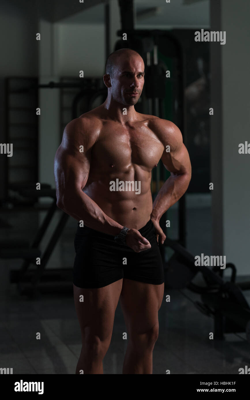 Bodybuilder Posing In Different Poses Demonstrating Their Muscles ...