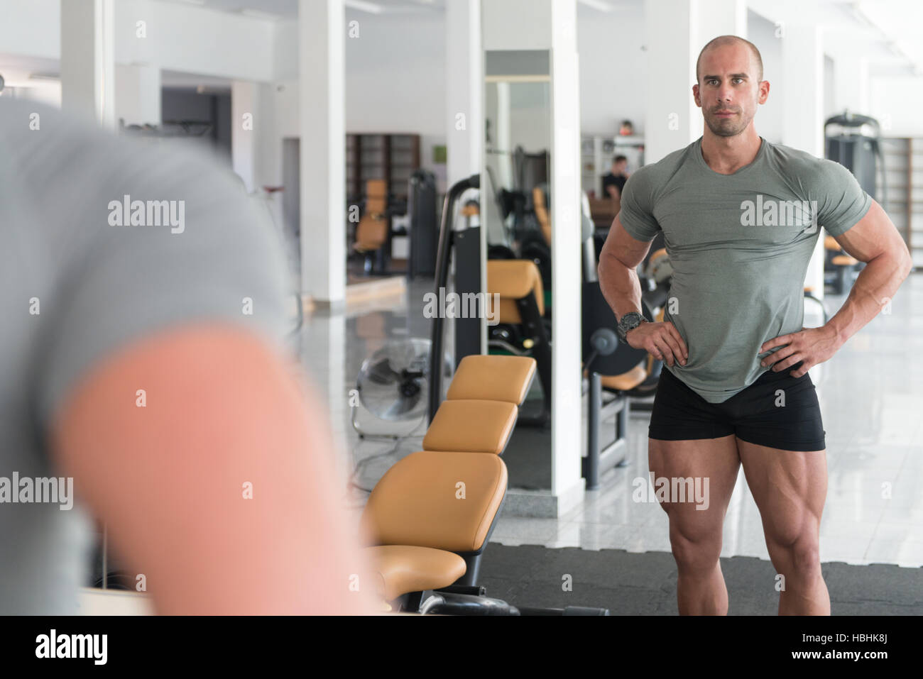 Man Standing Strong In The Gym And Flexing Muscles - Muscular Athletic ...