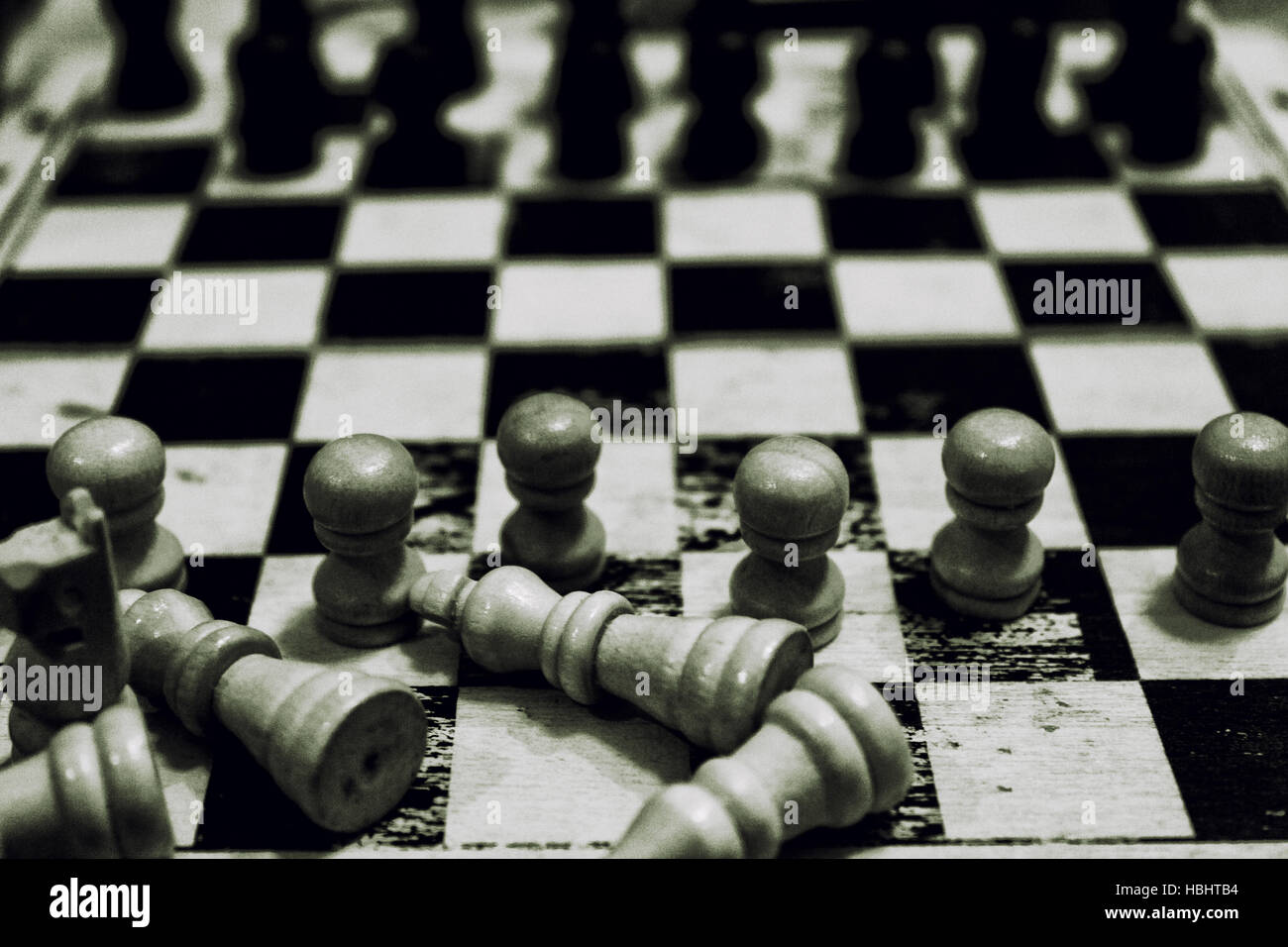 Chess pieces scatted in disarray after losing Stock Photo - Alamy