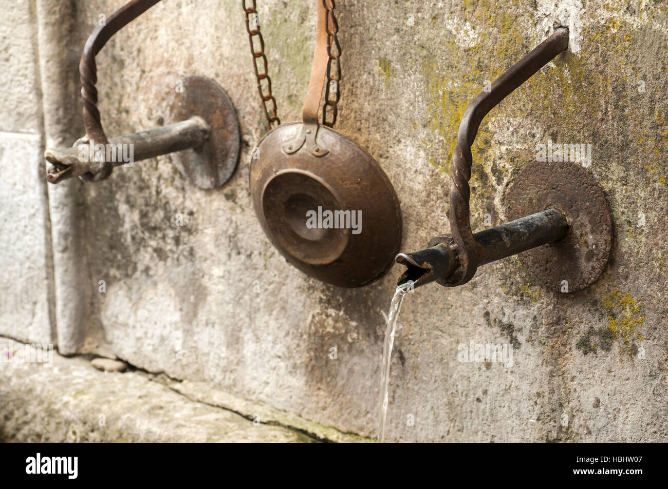 Spout of old stone fountain Stock Photo - Alamy