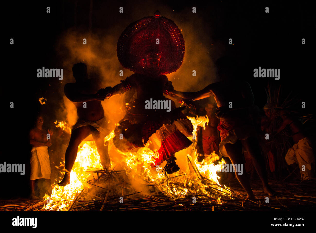 Theyyam performer jumping through fire. Kandanar kelan theyyam. Rapidly ...