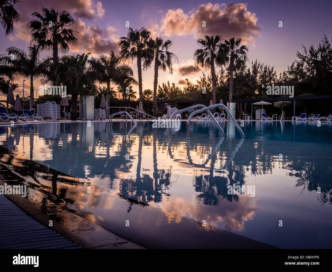 Swimming pool at dusk Stock Photo - Alamy
