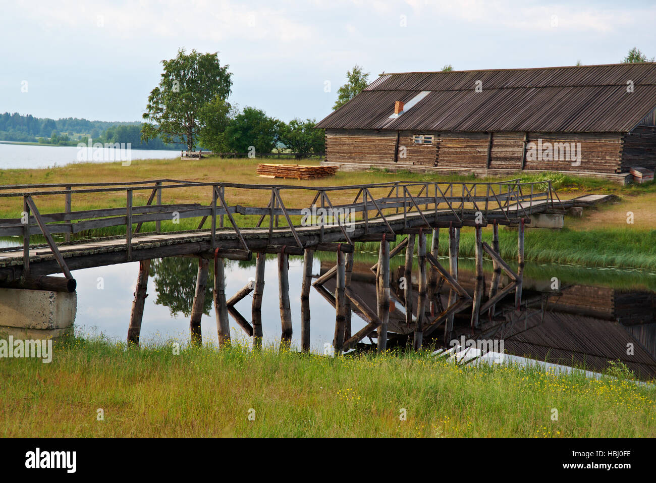 Wooden footbridge over pond Stock Photo - Alamy