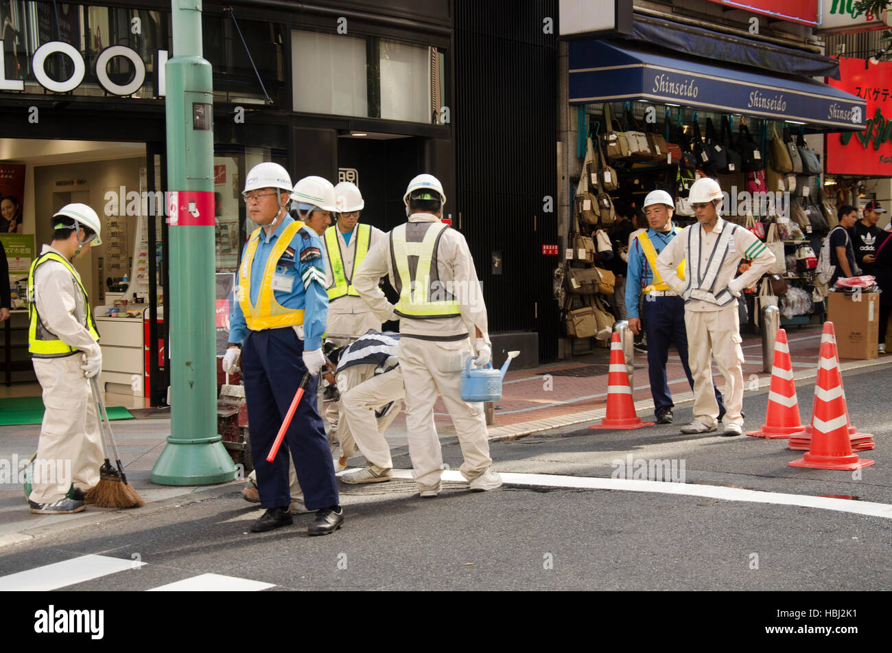 Japanese people in construction site working and repair surface of road ...
