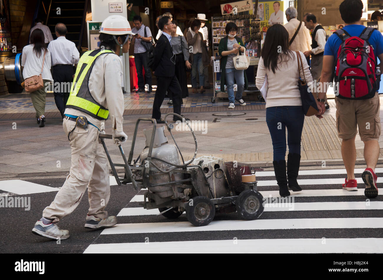 Japanese people in construction site working and repair surface of road ...