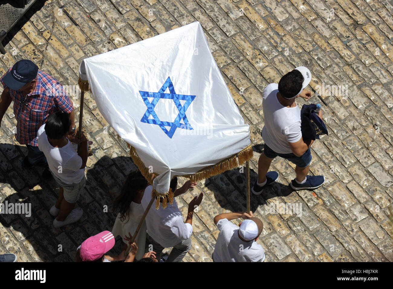 Participants of a Jewish Bar Mitzvah celebration carry a chuppah near ...