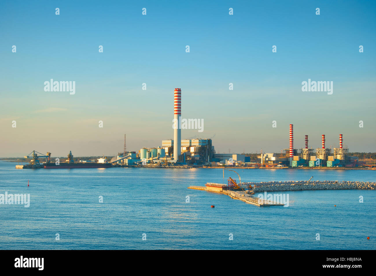 Industrial factory on seashore Stock Photo - Alamy