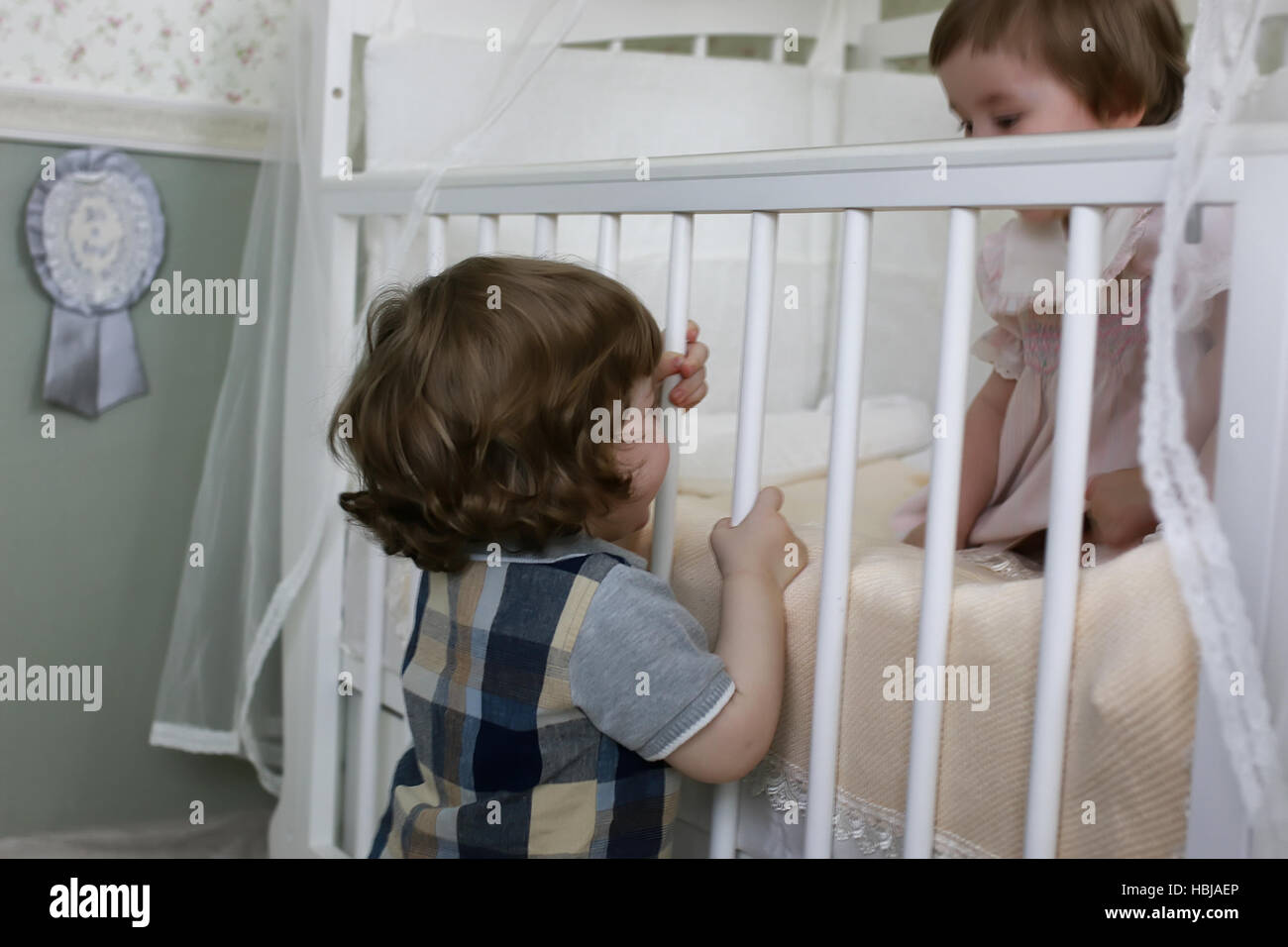 little kid sit in cot Stock Photo - Alamy
