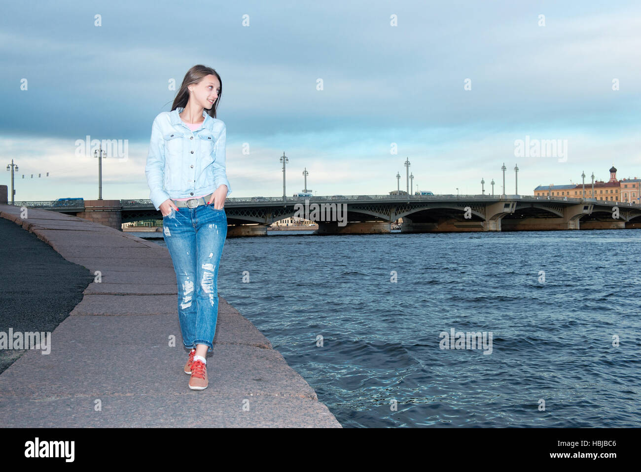 Woman walking along the waterfront Stock Photo - Alamy