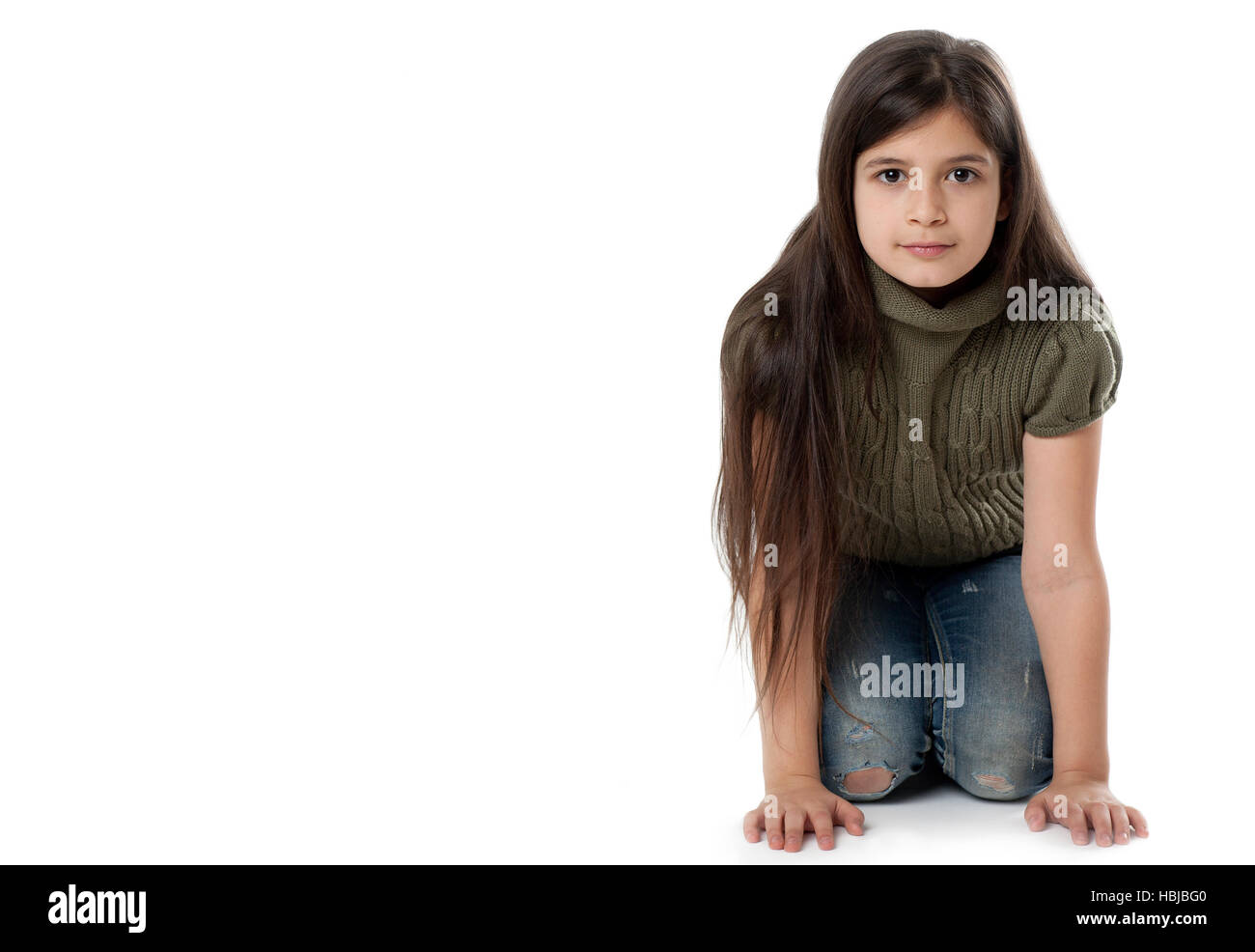 Young girl sitting on the ground Stock Photo - Alamy