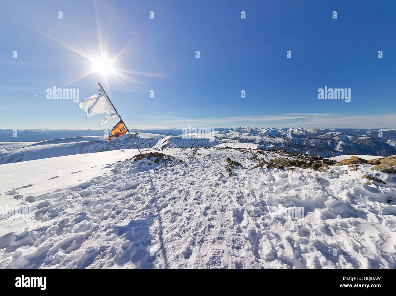 Panorama tattered flag on top of the mountain under sun Stock Photo - Alamy